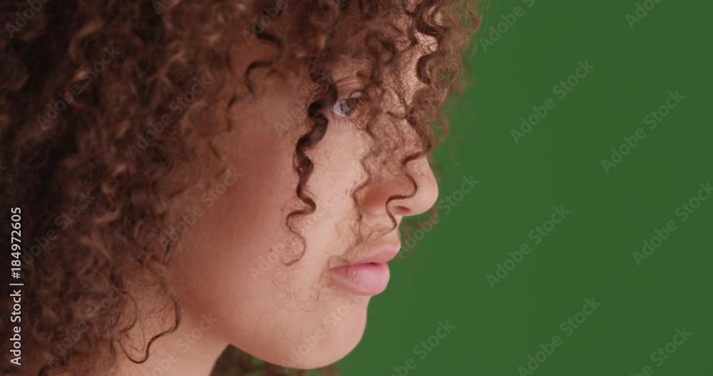 Black girl poses for a portrait on green screen. On green screen to be ...
