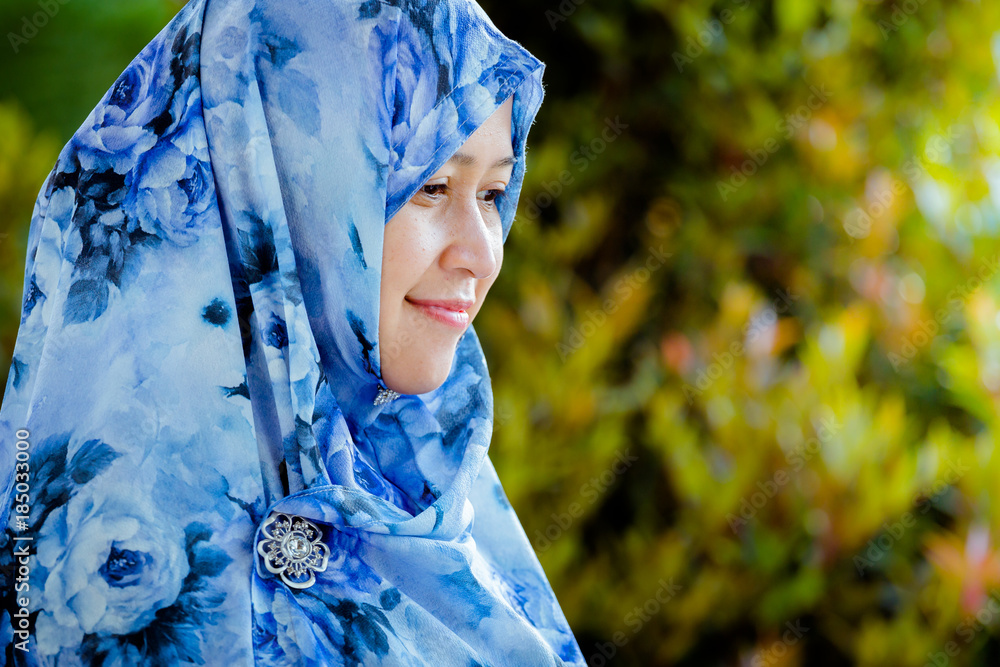 Indonesian muslim model wearing hijab with green nature background ...