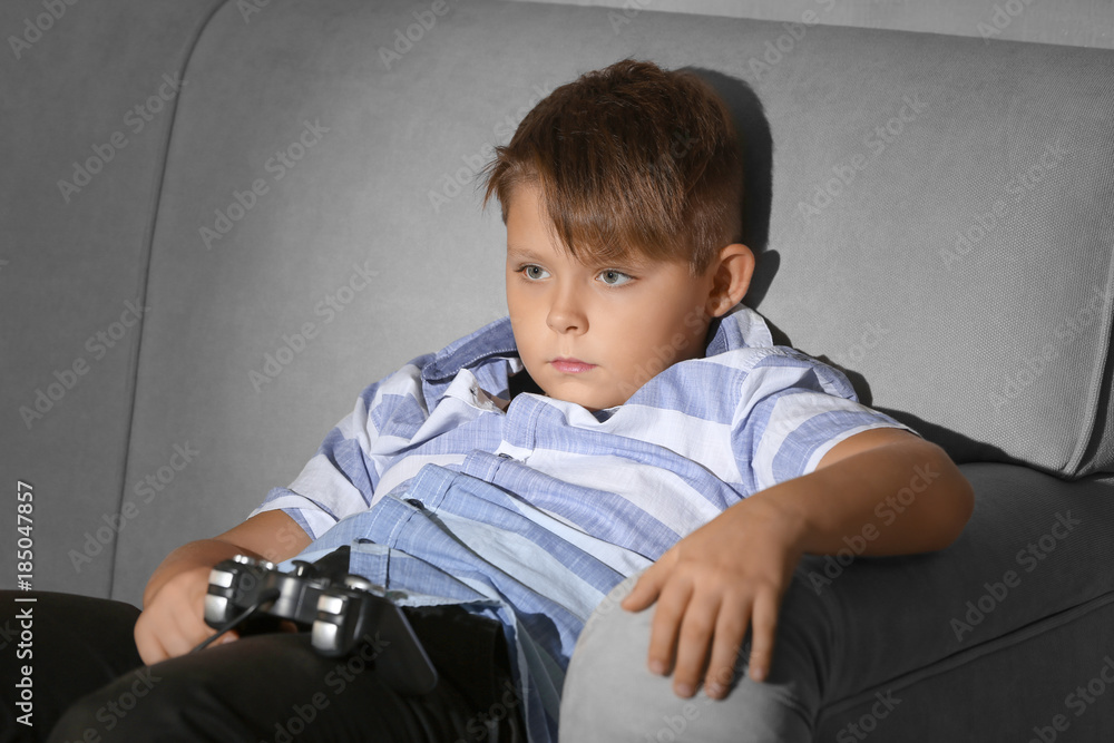 Overweight boy playing video game at home Stock Photo | Adobe Stock