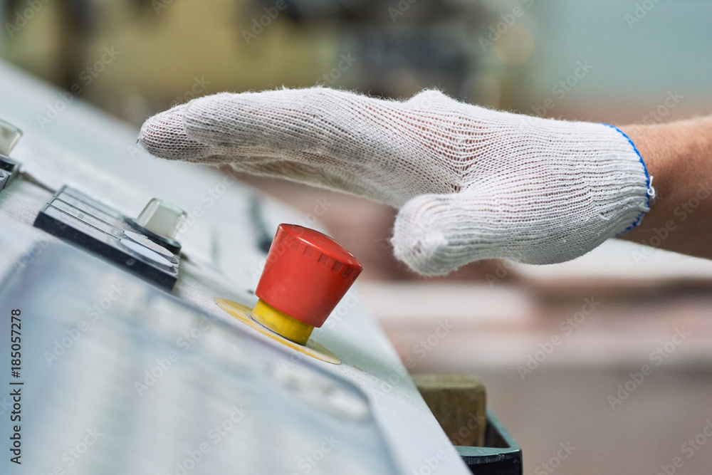 Foto de Side view close up of male hand in working glove pressing big ...