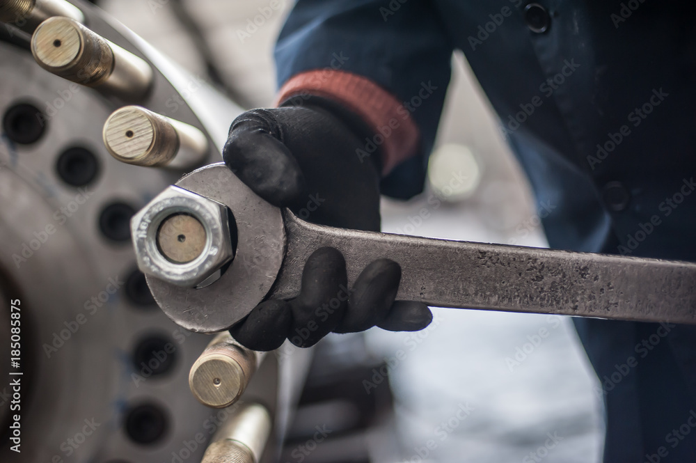 Mechanic screws big bolt with large and heavy wrench key Stock Photo ...