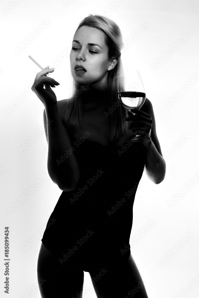 Beautiful blonde girl in black body and heels with visible shadow Stock Photo | Adobe Stock