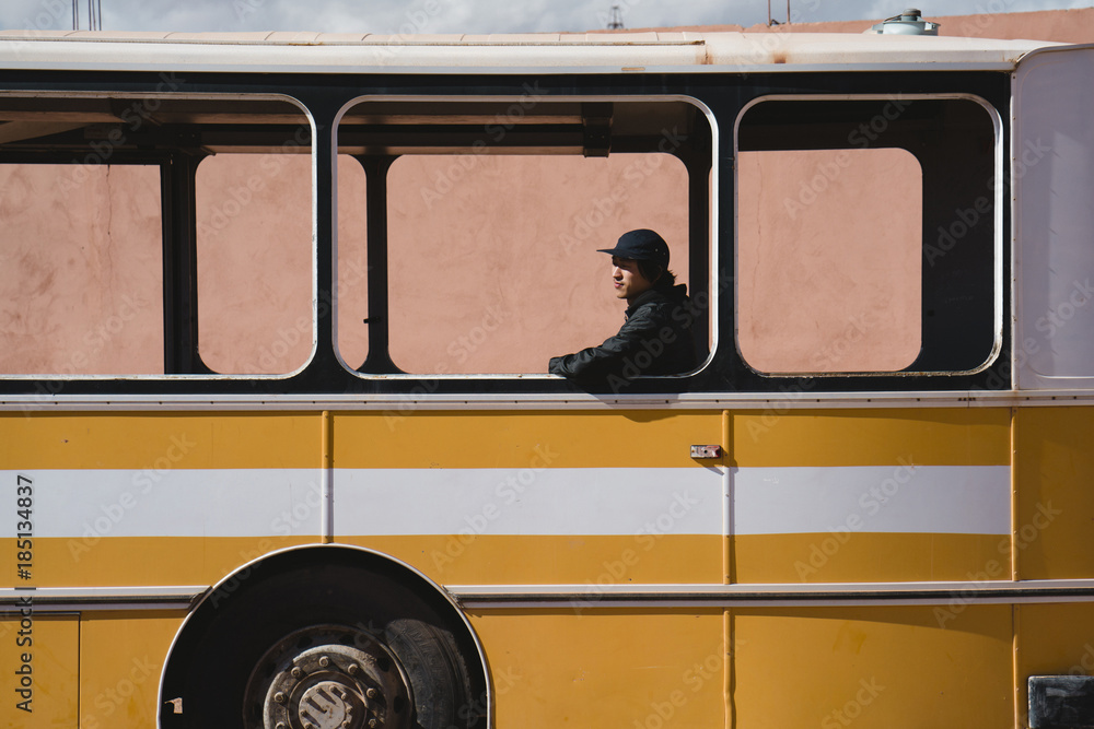 Man looking away while sitting in bus seen through window Stock Photo ...