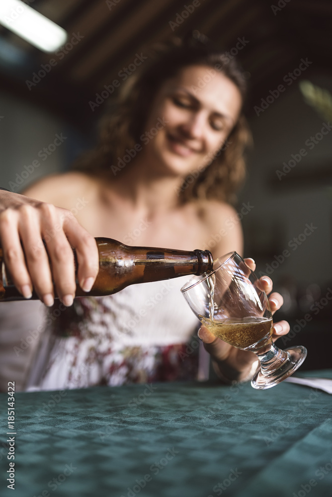 Beautiful woman drinking a beer in a bar. Stock Photo | Adobe Stock