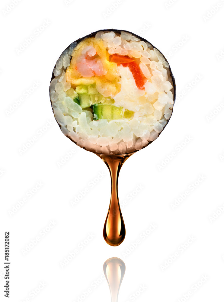 Drop of soy sauce drips from a sushi roll on white background Stock ...
