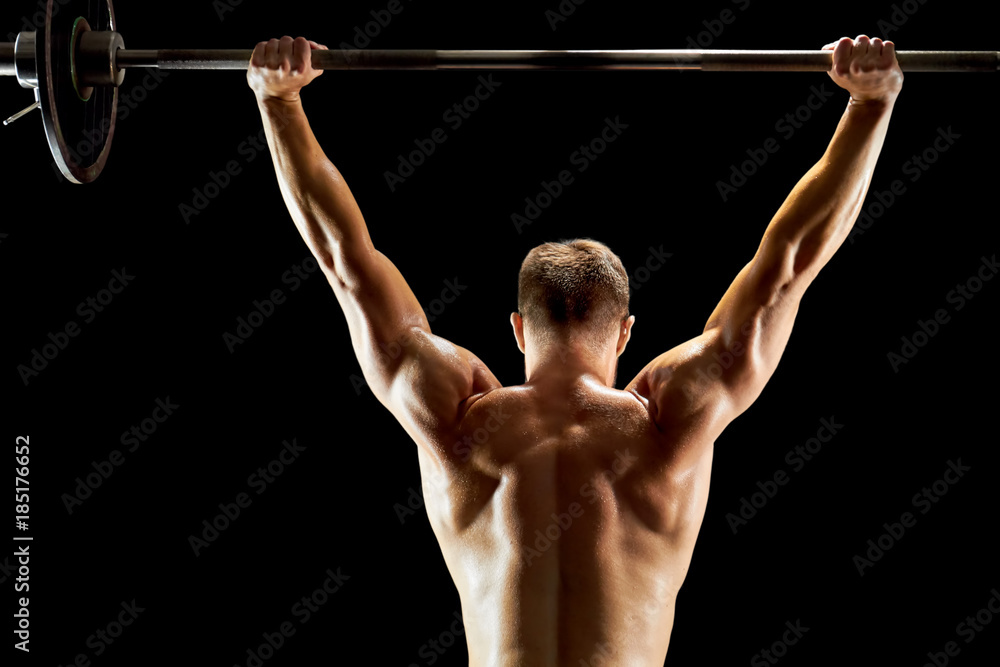 Persistent man lifting a barbell. Building a perfect body, lifting ...
