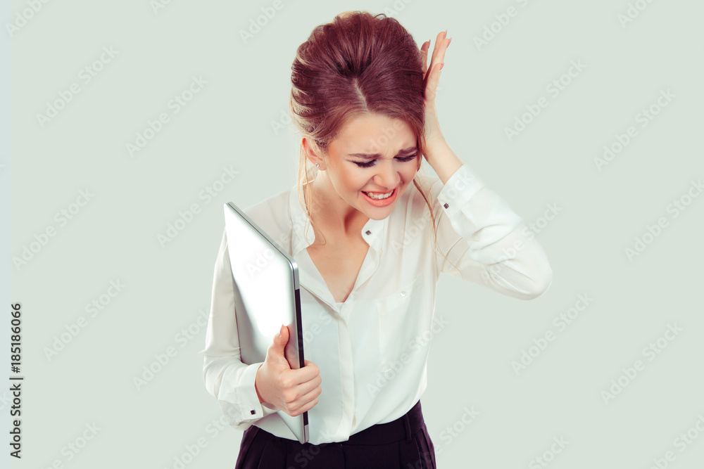 Angry furious businesswoman holding computer, screaming hand on head ...