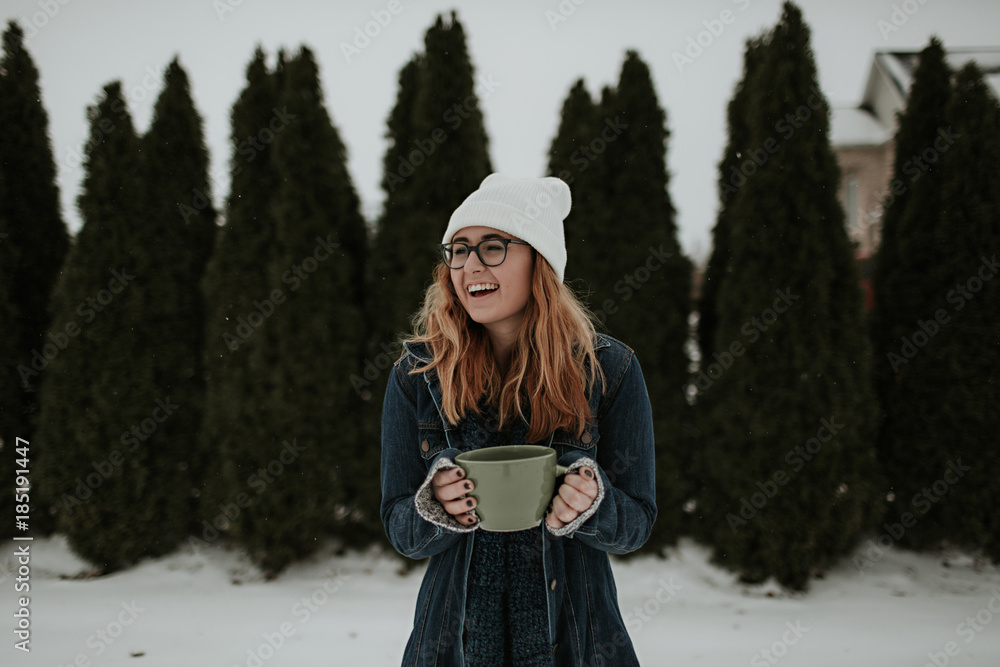 Lifestyle photo of a girl drinking from a large mug outdoors in the ...