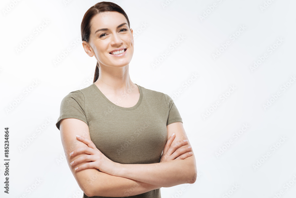 Female protector. Happy energetic female soldier crossing arms and ...