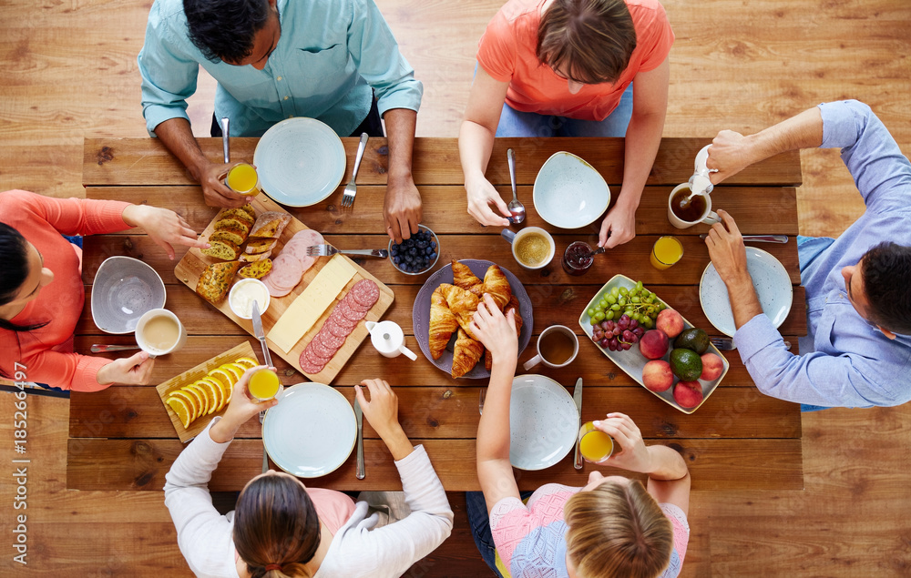 group of people having breakfast at table Stock Photo | Adobe Stock