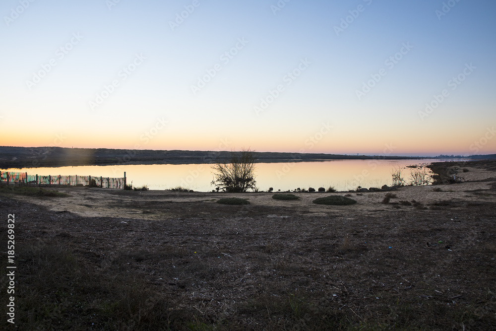 sunset with shy reflection in still water over nature reserve Casse de ...