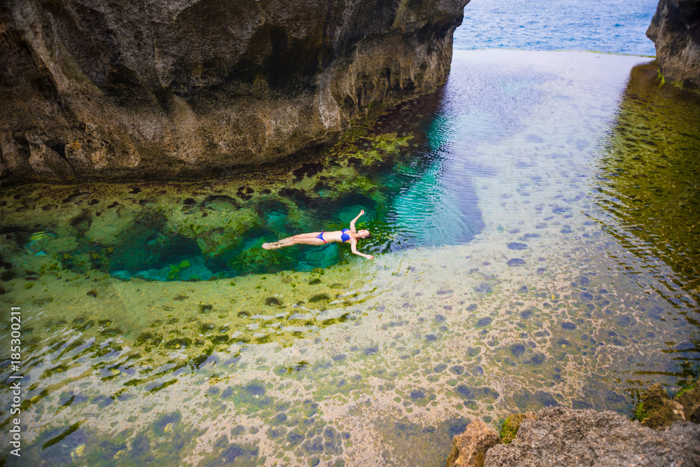 Woman swimming in Angel's Billabong is natural infinity pool on the ...