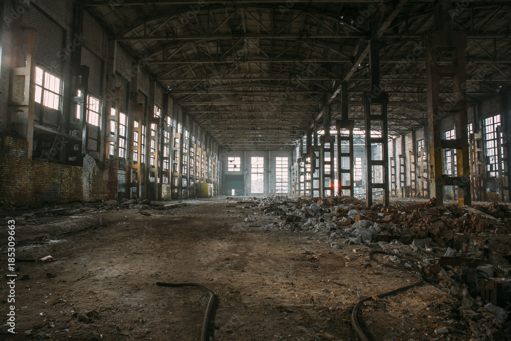 Dark creepy ruins of demolished abandoned large industrial warehouse or ...