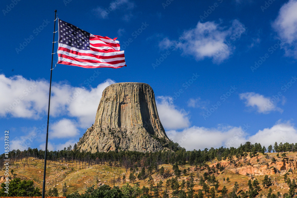 American Flag flies above Devil's tower, a famous national monument ...