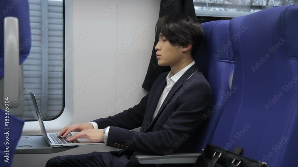 Video Stock Young Korean businessman working with laptop sitting in ...