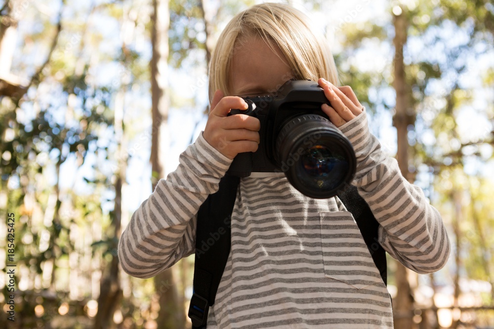 Little girl with a backpack holding dslr camera Stock Photo | Adobe Stock