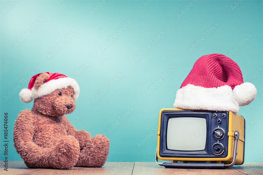 Teddy Bear toy watching retro TV in Santa hat front mint green ...