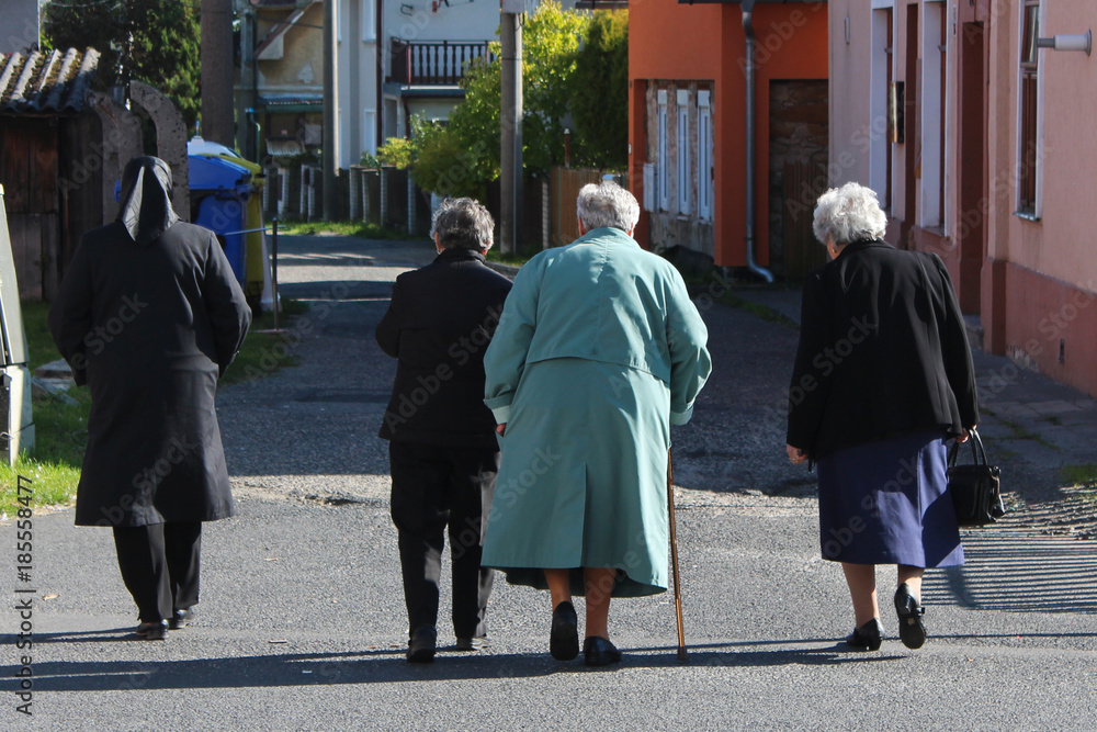 Four old ladies friends walking down the street Stock Photo | Adobe Stock