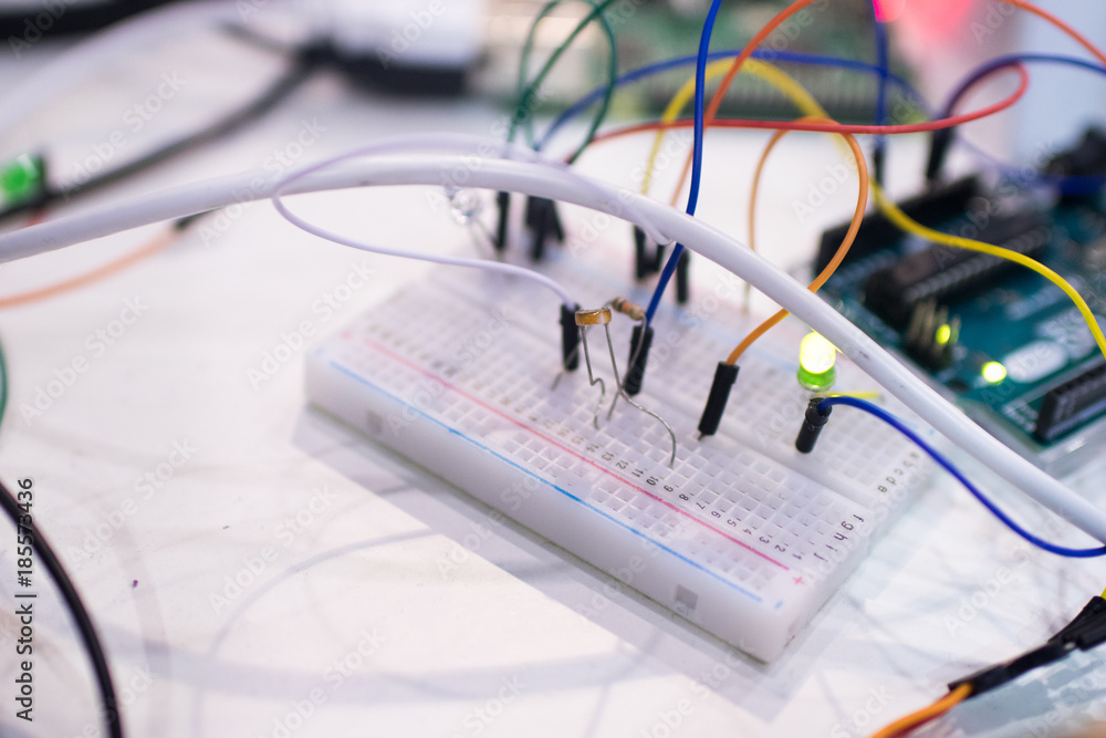 Breadboard and microcontroller with circuit and light sensor. STEAM and ...