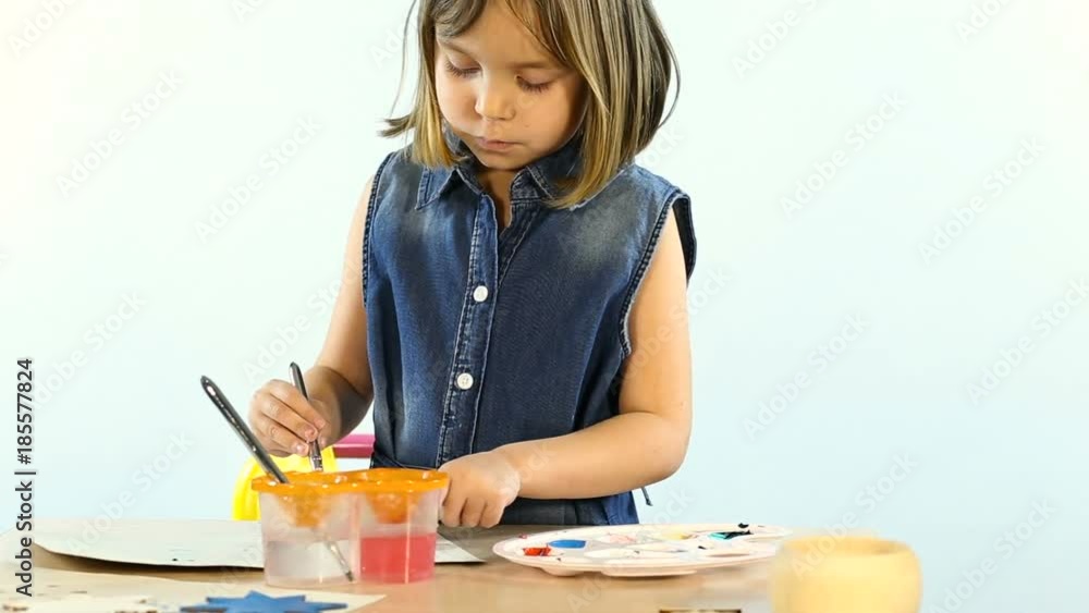 Portrait, the face of a girl of European appearance. She's busy drawing ...