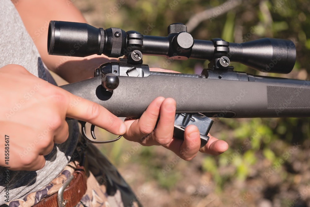 Hunter ready to shoot with sniper rifle Stock Photo | Adobe Stock