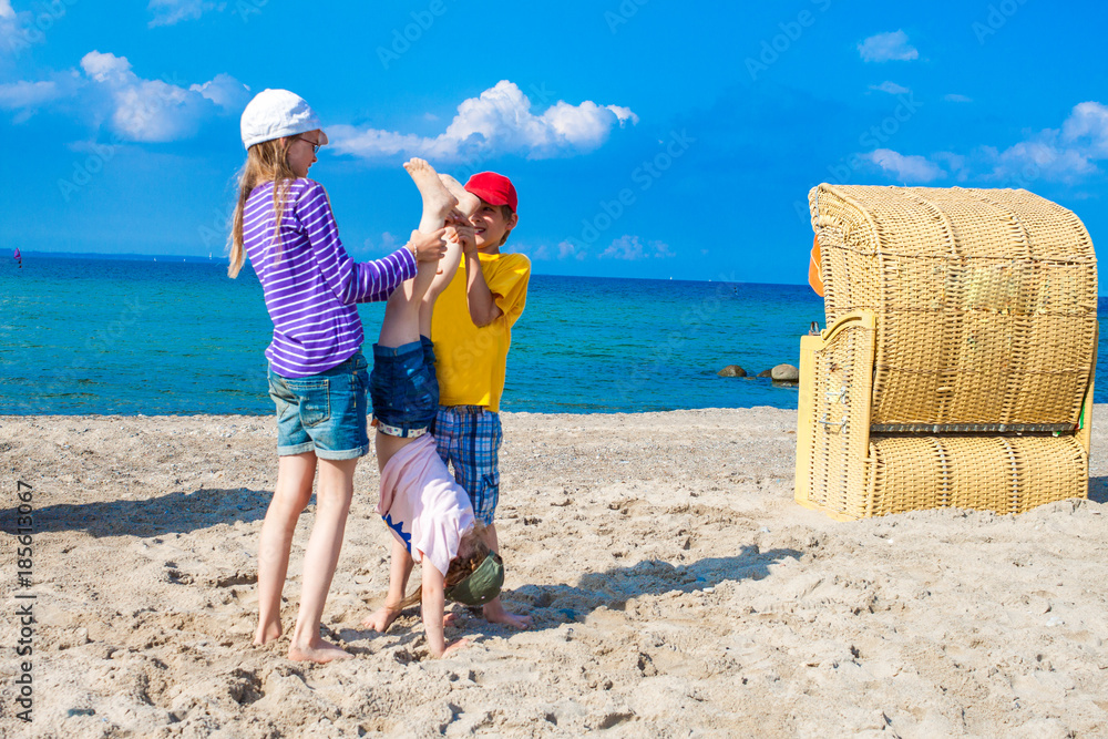 Kinder akrobatische Übung Handstand am Strand am Meer in Deutschland ...