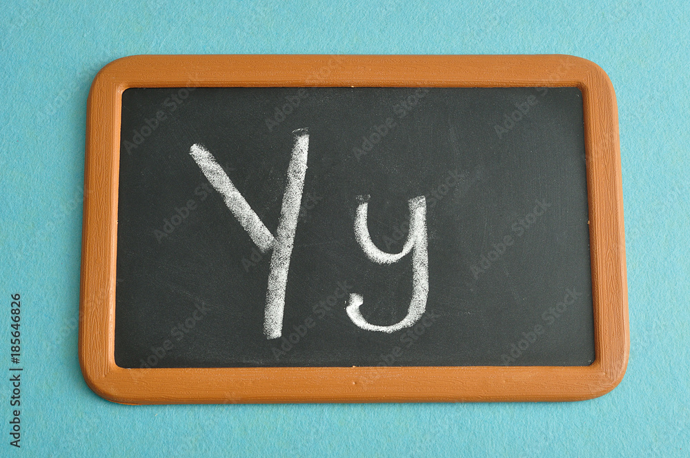 A black board with the alphabet letter Y in a capital and small letter ...