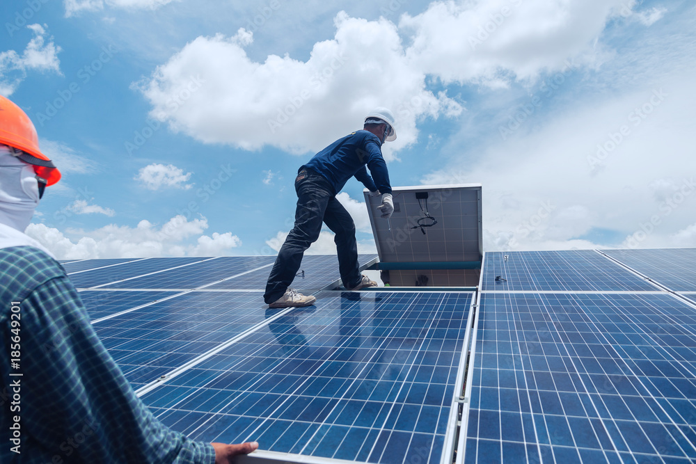 engineer team working on replacement solar panel in solar power plant ...