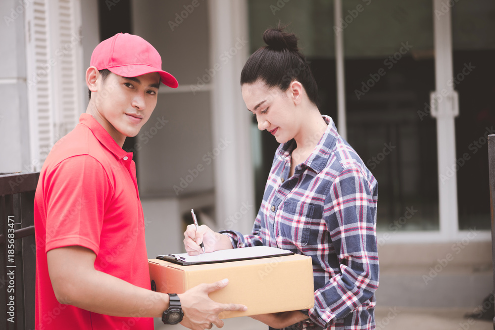 Young logistic career concept. Happy delivery man giving his package to ...