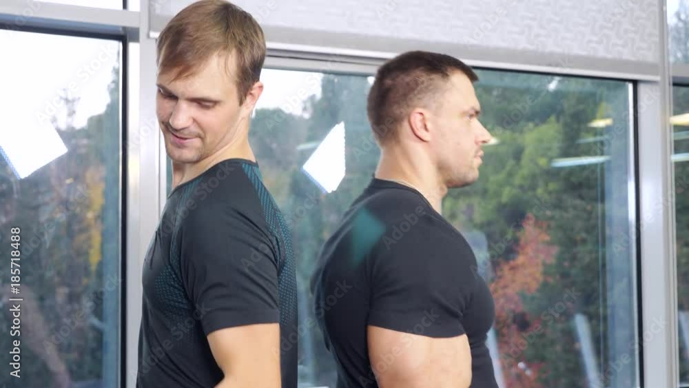 Young beginner sportsman makes training on the simulators, led by his ...