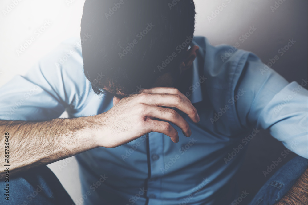 sad man sitting Stock Photo | Adobe Stock