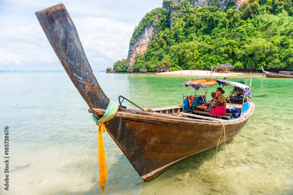 tourists on a sea walk on a traditional Thai boat long tail in Thailand ...