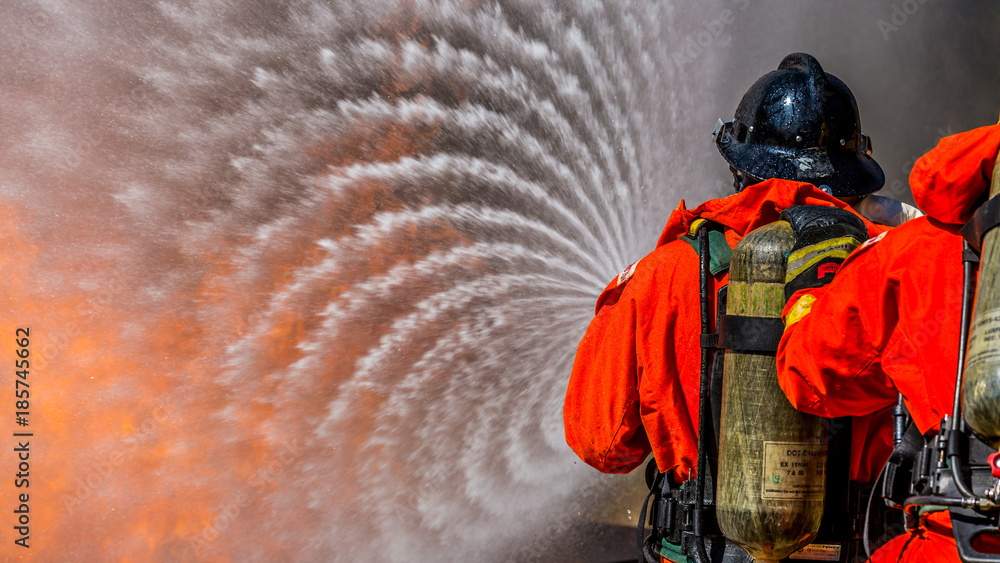 Firefighter in fire fighting operation, Firefighter using extinguisher ...