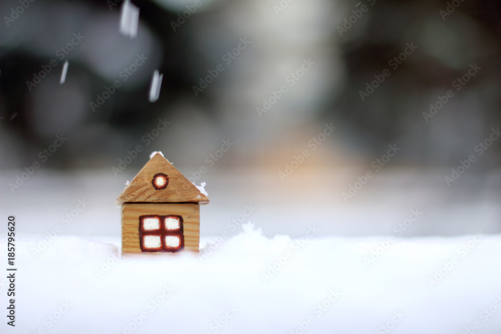 cold season/ wooden house with windows and a triangular roof in the ...