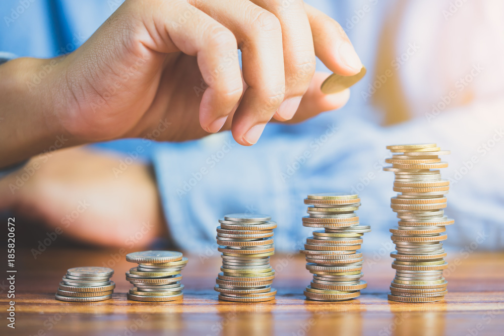 man hand stack coins to show for business accounting concept growing ...