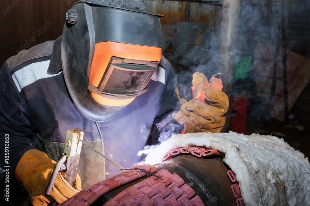Welder in the shop weld sample from the tube with concomitant heating ...