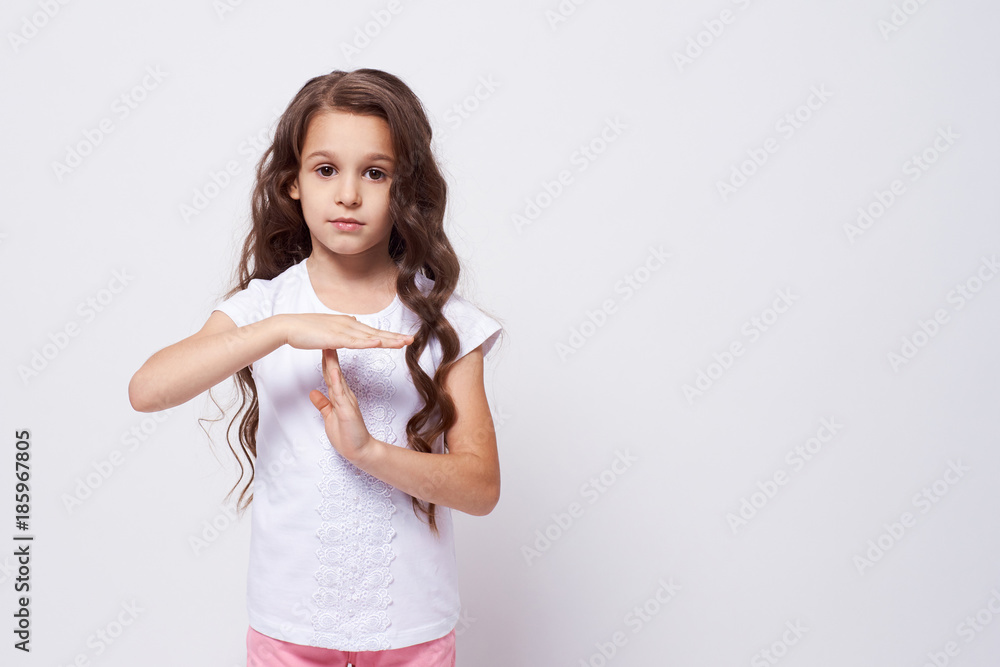 Little girl. Stop gesture. White background Stock Photo | Adobe Stock