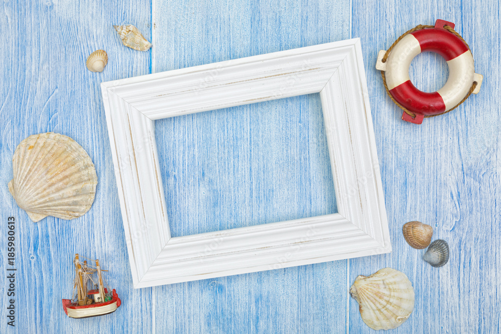 maritime blue weathered wood background with lifebuoy, sea shells and ...
