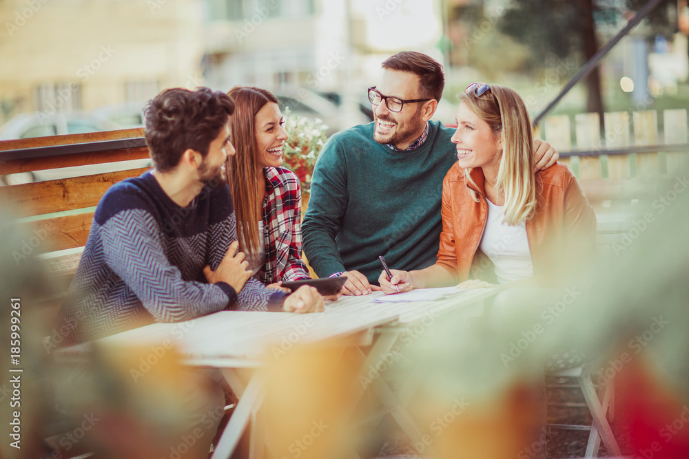 Group of four friends having fun a coffee together. Two women and two ...