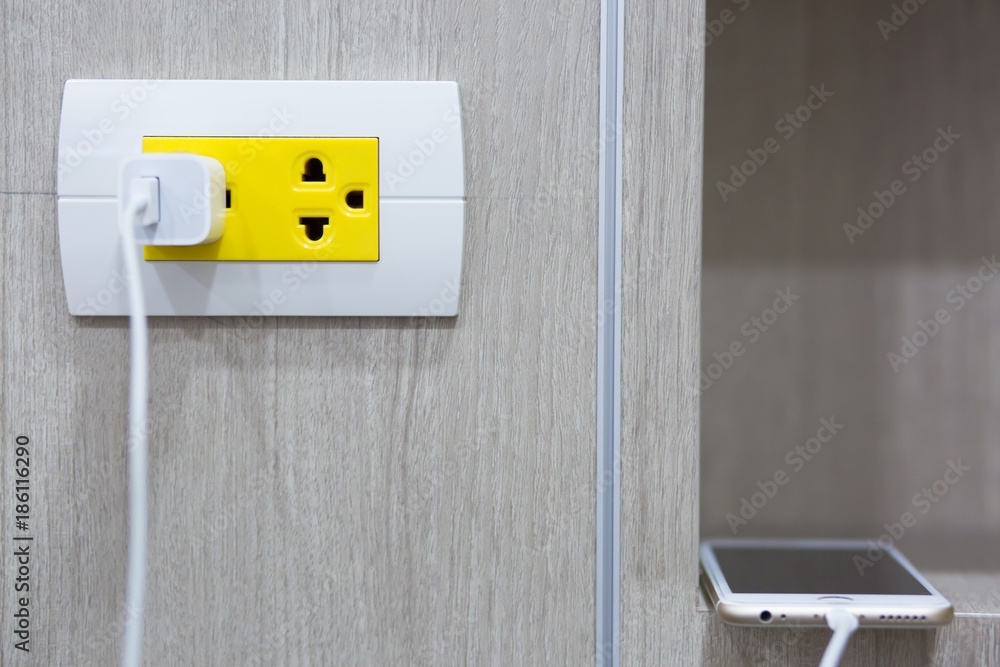 plugging adapter charge the battery with outlet socket plug and hold ...