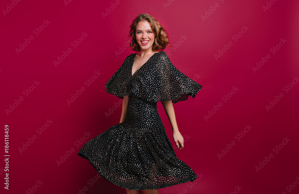 Indoor photo of magnificent young woman in long dress dancing on claret ...