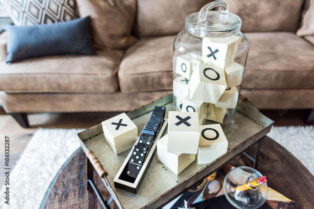 Game room tray stand with x and o, dominoes, on coffee table in staging ...