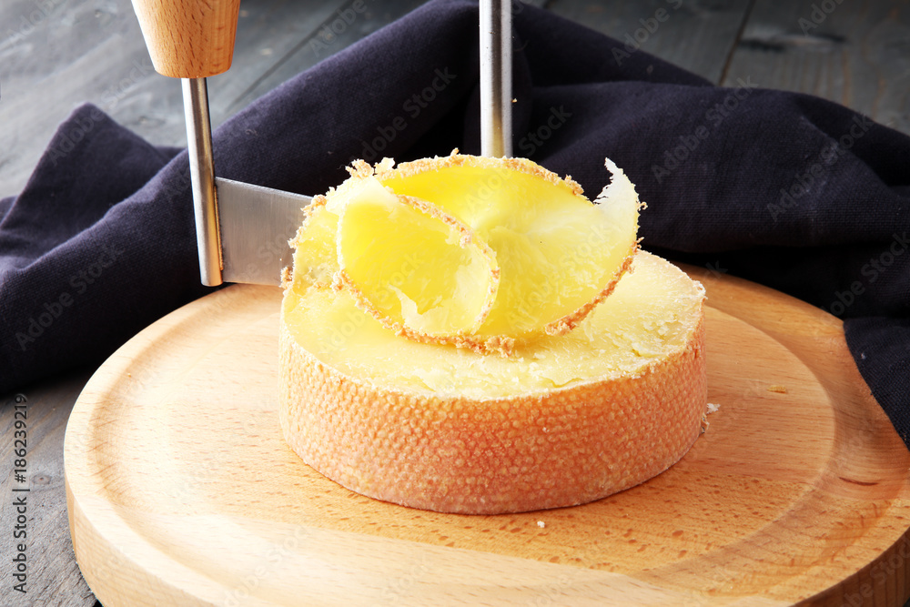 Special cheese knives. The girolle scraper in cheese wheel. Cheese ...