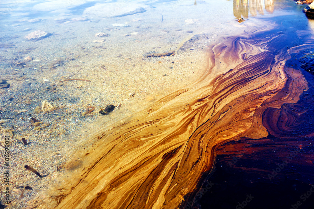 Texture of crude oil spill, pools of crude oil floating on the surface ...