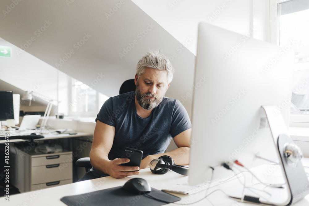 Man at an office desk Stock Photo | Adobe Stock