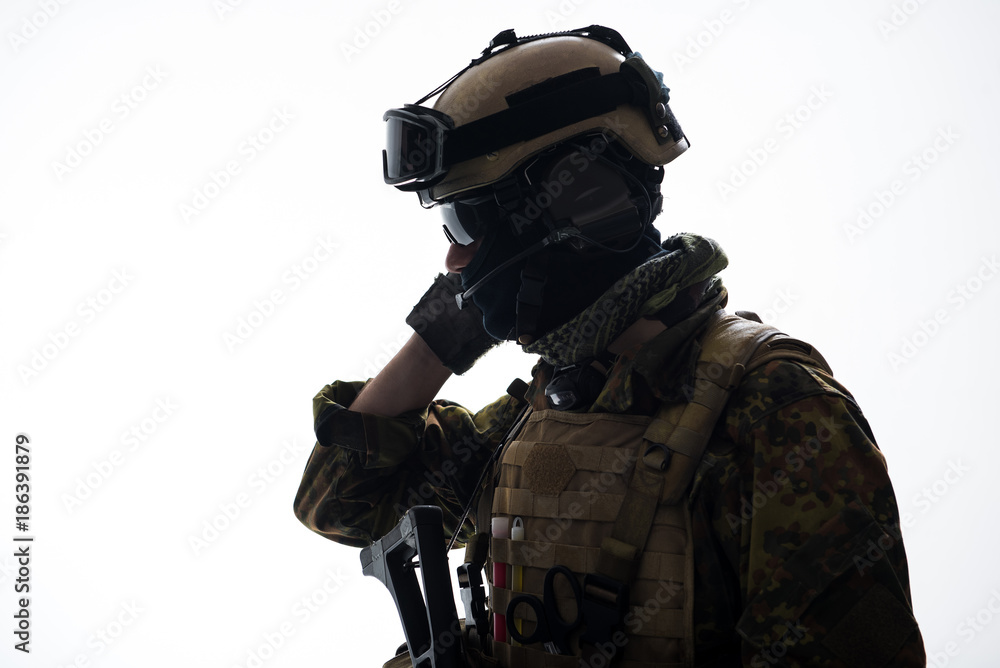 Side view serene soldier telling by special earphones. Conversation and ...