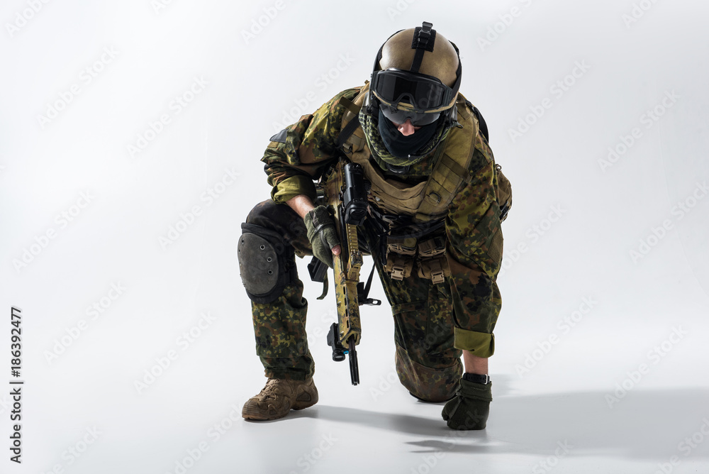 Stockfoto Portrait of tired soldier kneeling and leaning on arm while ...