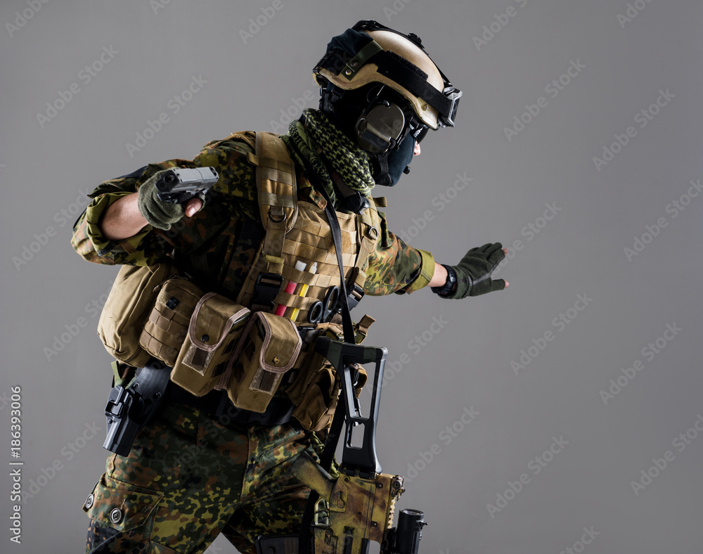 Stop. Side view severe soldier holding gun while gesticulating arm ...