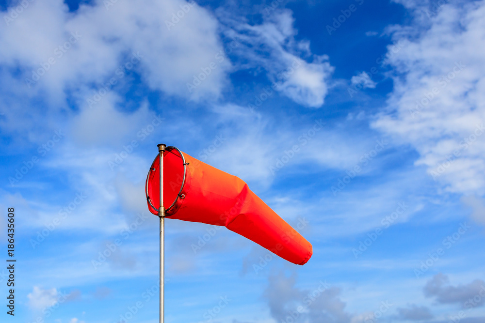 Orange wind sock in blue sky and white cloud background. Stock Photo ...