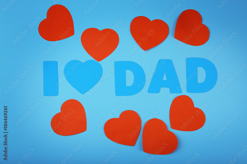 Greeting for Father's day with phrase "I LOVE DAD" and paper hearts on ...